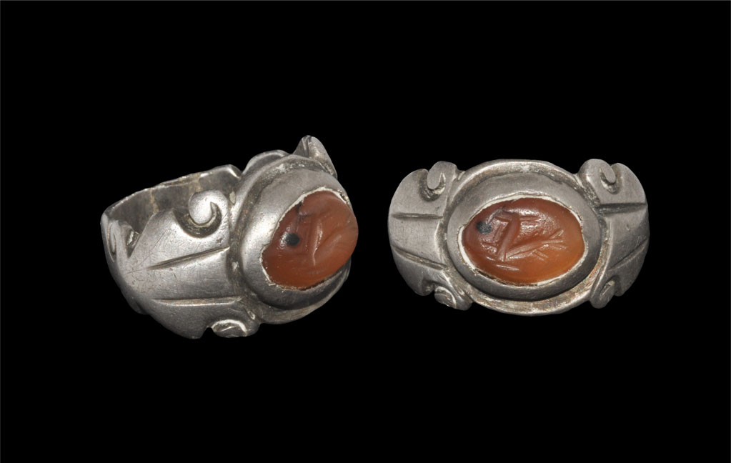 A Roman amber intaglio Legionnaires - auctions & price archive